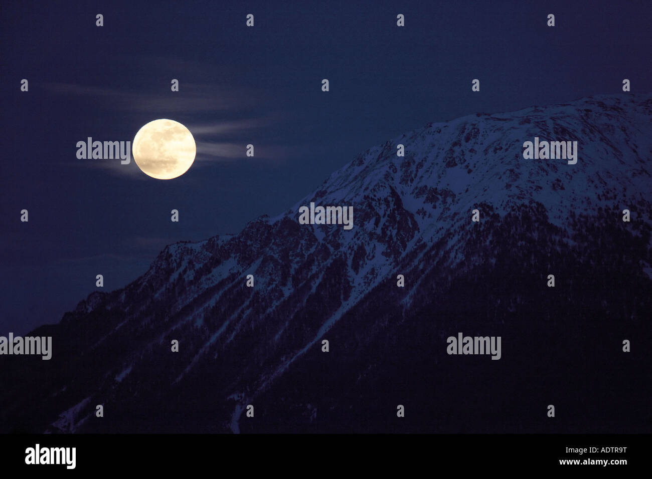 full moon rising over the swiss alps Stock Photo - Alamy