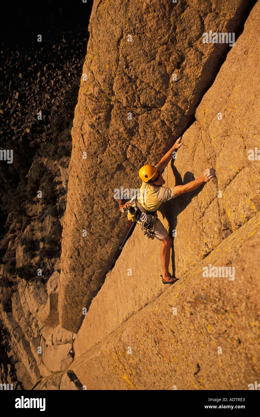 Male rock climber ascending a steep route on Devil's Tower in Wyoming ...