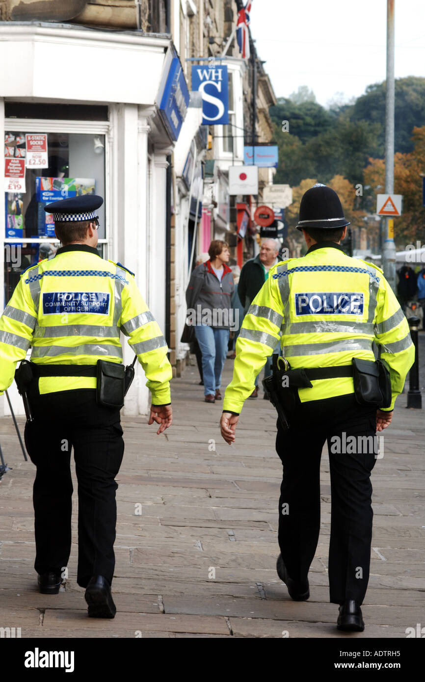 Policeman and Community Safety Officer patrol a High street Skipton ...