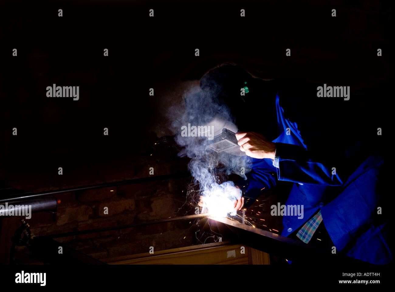 Mechanic welding steel in workshop, trade, building construction Stock ...