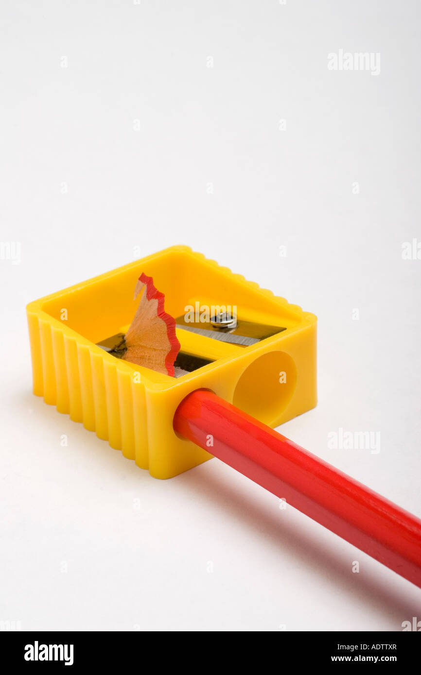 Red pencil and yellow pencil sharpener on a white background Stock ...