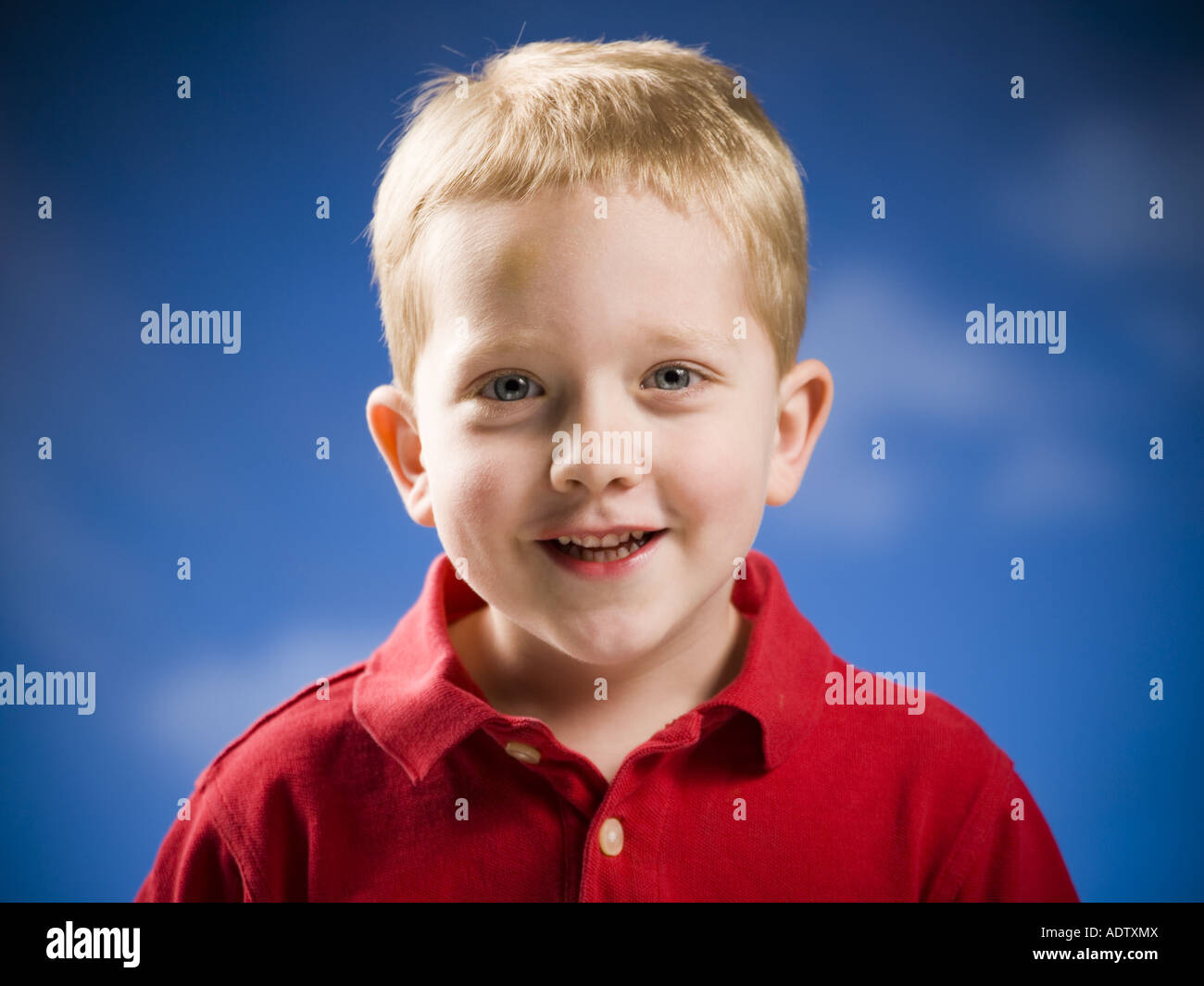 Boy smiling with blue sky and clouds Stock Photo - Alamy