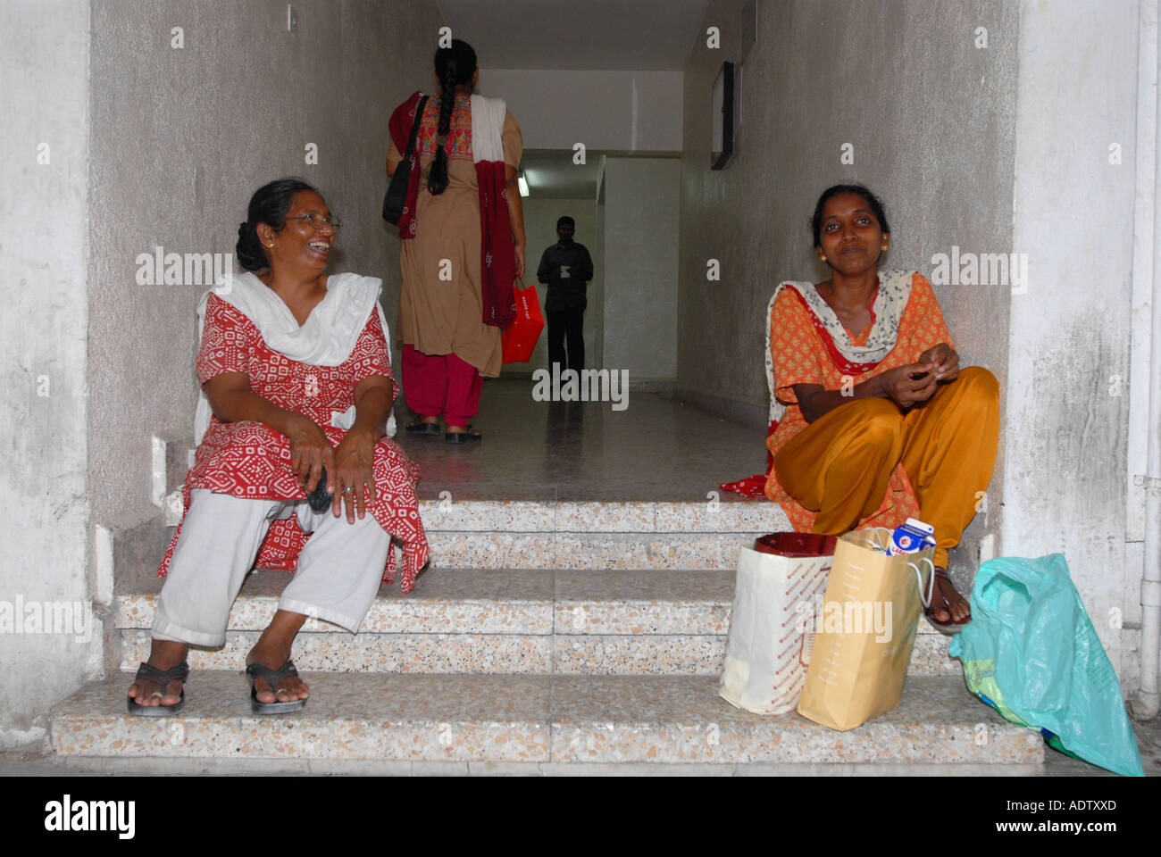 two indian women sat on a step Stock Photo - Alamy