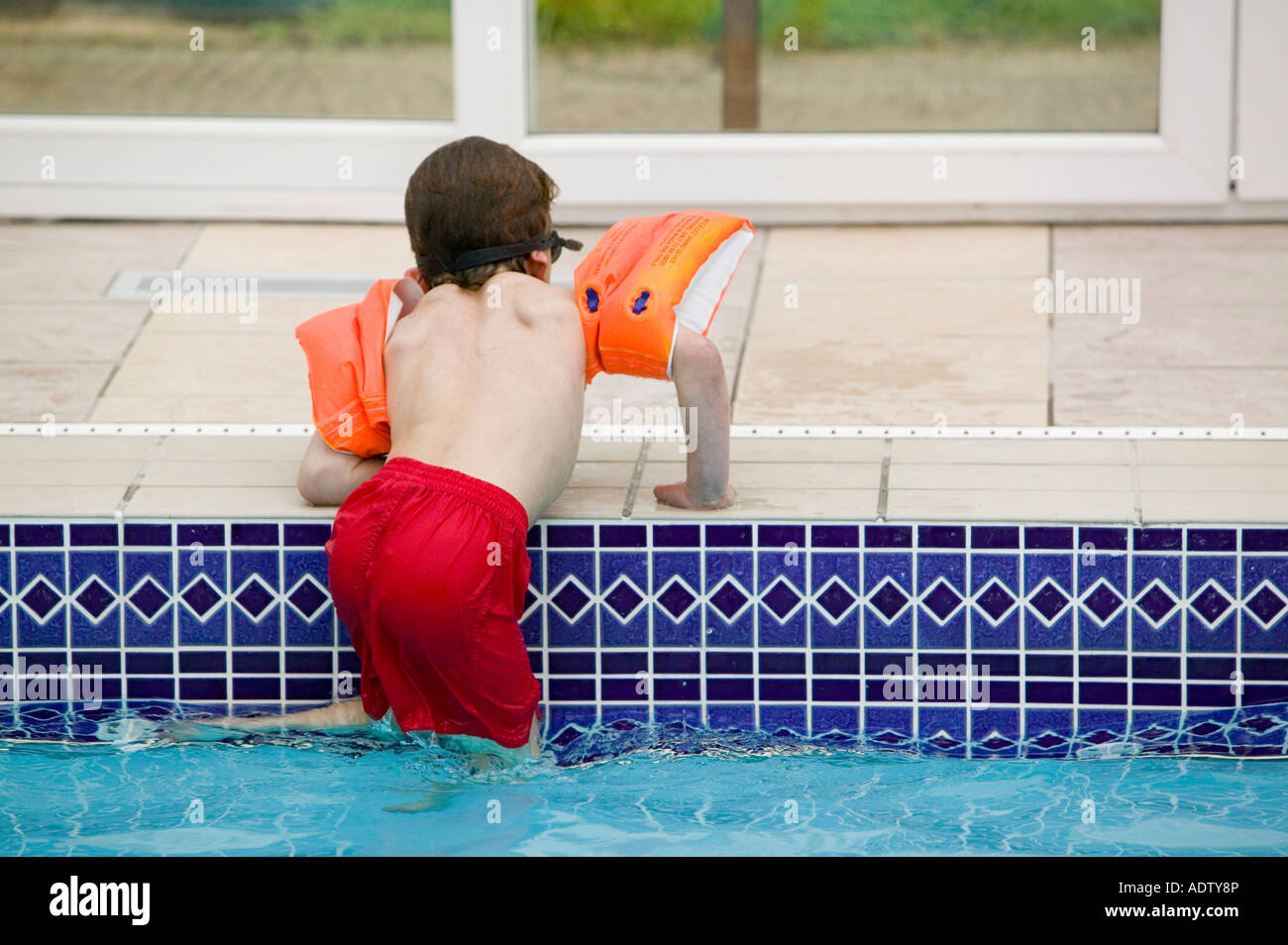 Climbing out of swimming pool hi-res stock photography and images - Alamy