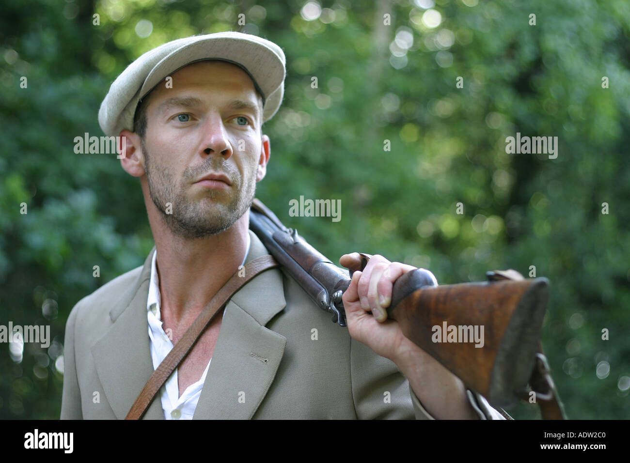 Man with gun on shoulder, portrait Stock Photo - Alamy