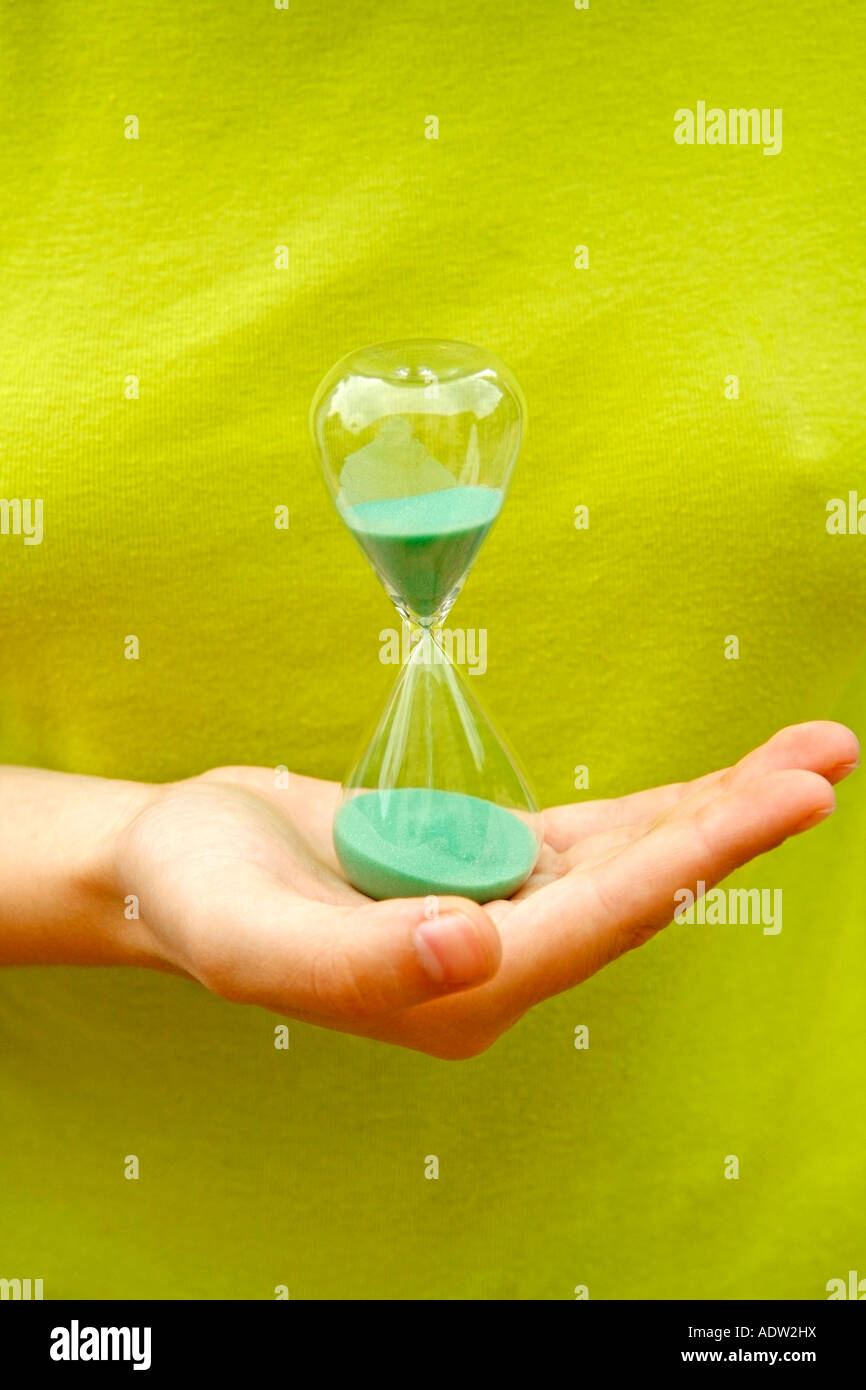 Female hands holding hourglass hi-res stock photography and images - Alamy
