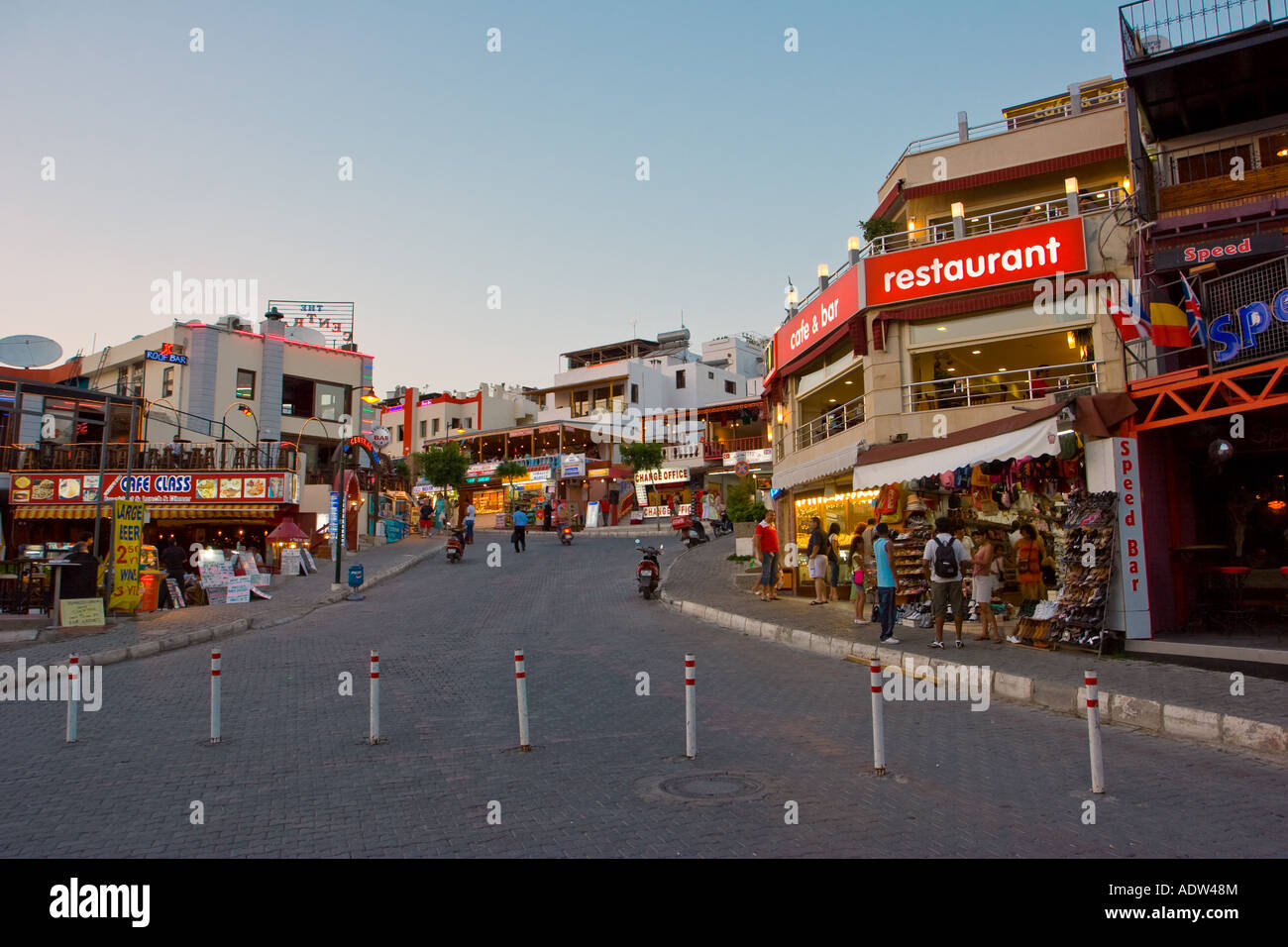People walking down the road at night in Gumbet doing shopping until ...