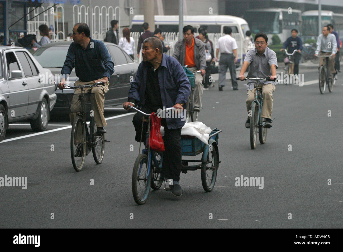 An old Beijing man wearing traditional Mao clothes cycles his three ...