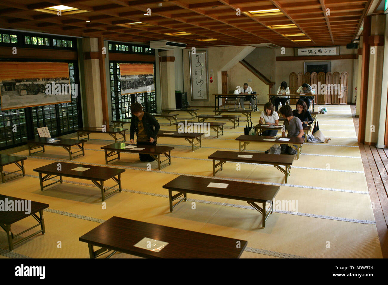 Japanese people write buddhist prayers on wooden tablets inside Sanzen ...