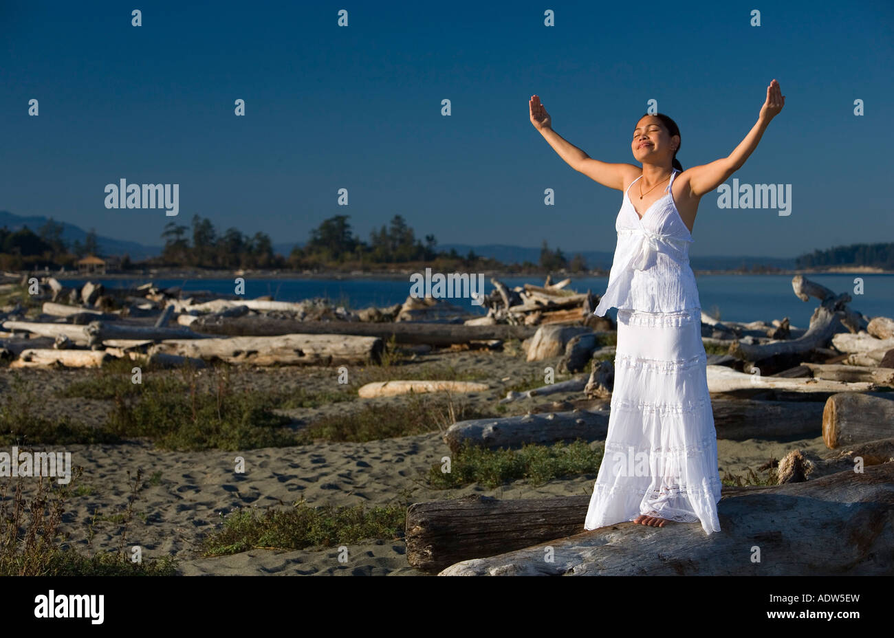 Woman praying at the beach Stock Photo - Alamy