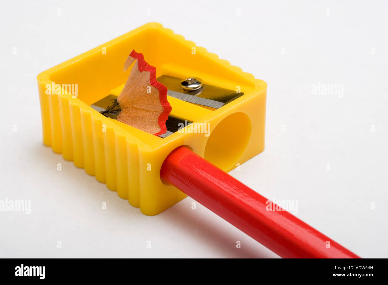 Red pencil and yellow pencil sharpener on a white background Stock ...