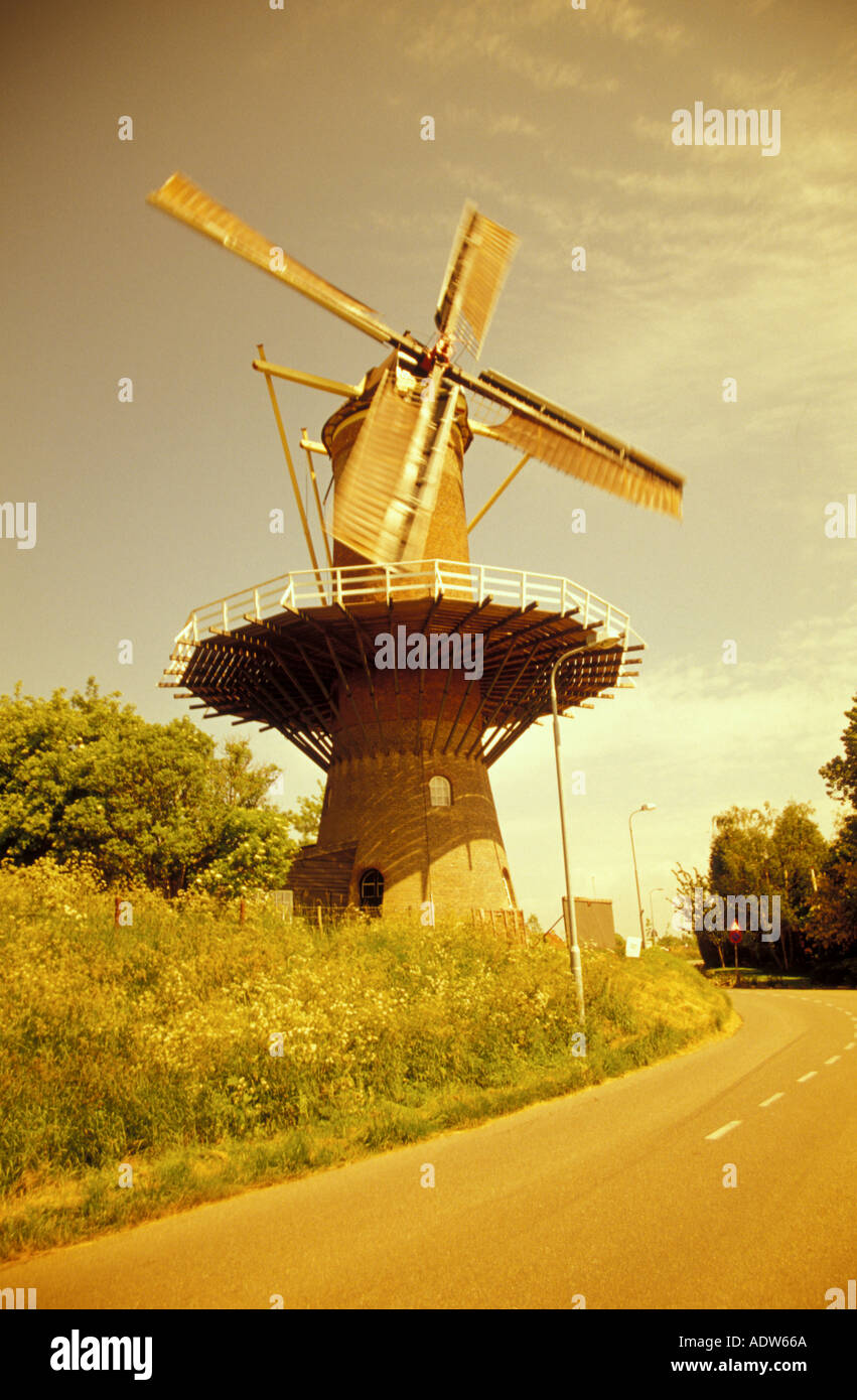 Netherlands, windmill by street Stock Photo - Alamy