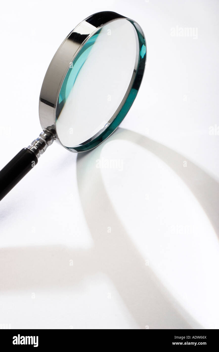 Magnifying glass casts a shadow over a white background Stock Photo - Alamy