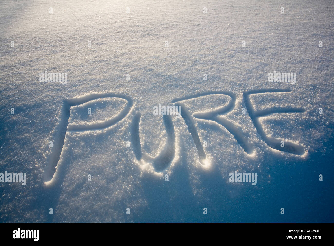 Pure written in the snow Stock Photo - Alamy