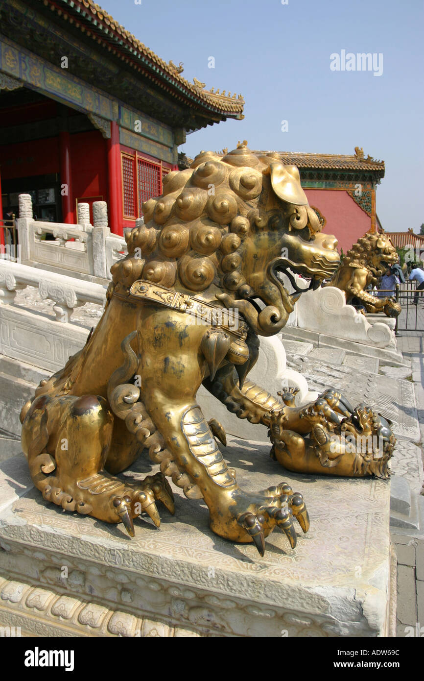 Bronze statue guards the steps and entrance to a temple building in the ...