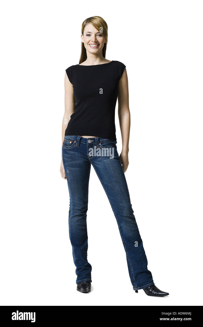 Woman standing and smiling Stock Photo - Alamy