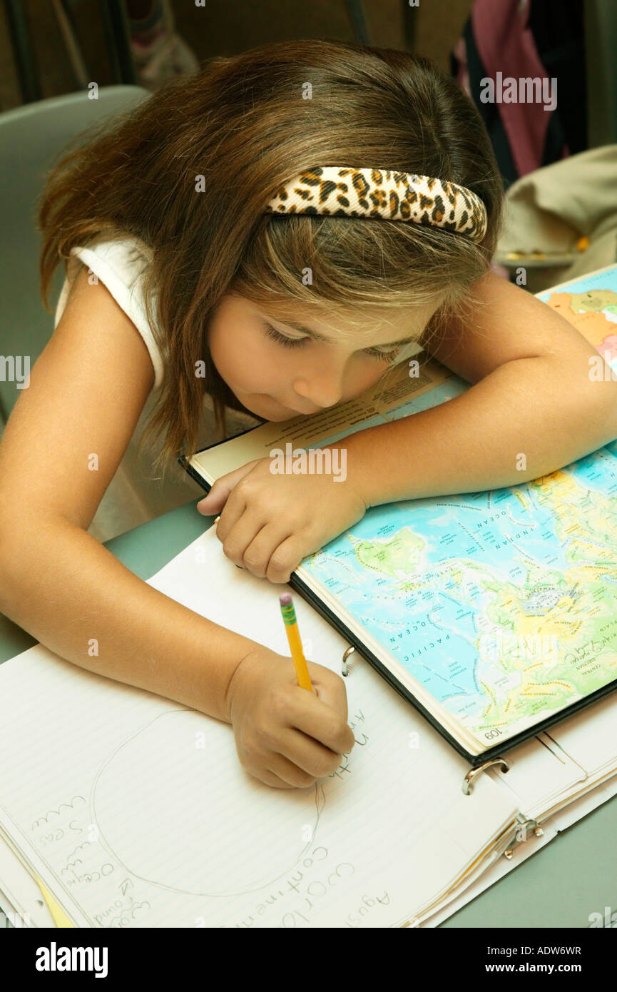 Child working on school work Stock Photo - Alamy