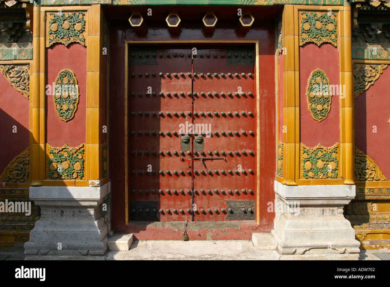 Classic Chinese architecture and a heavy red wooden door with metal ...