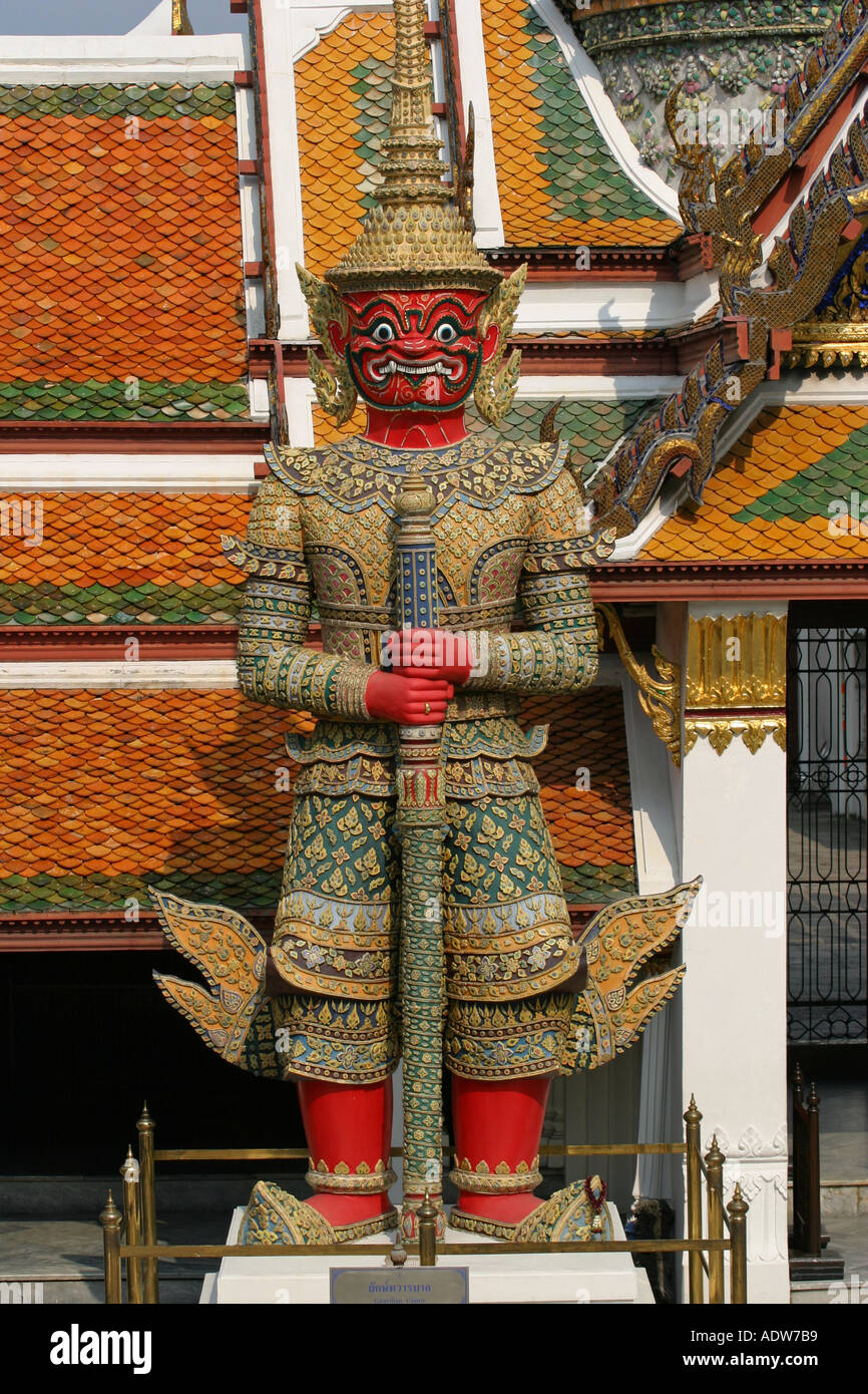 Large red guardian statue stands at an entrance to the Grand Palace ...