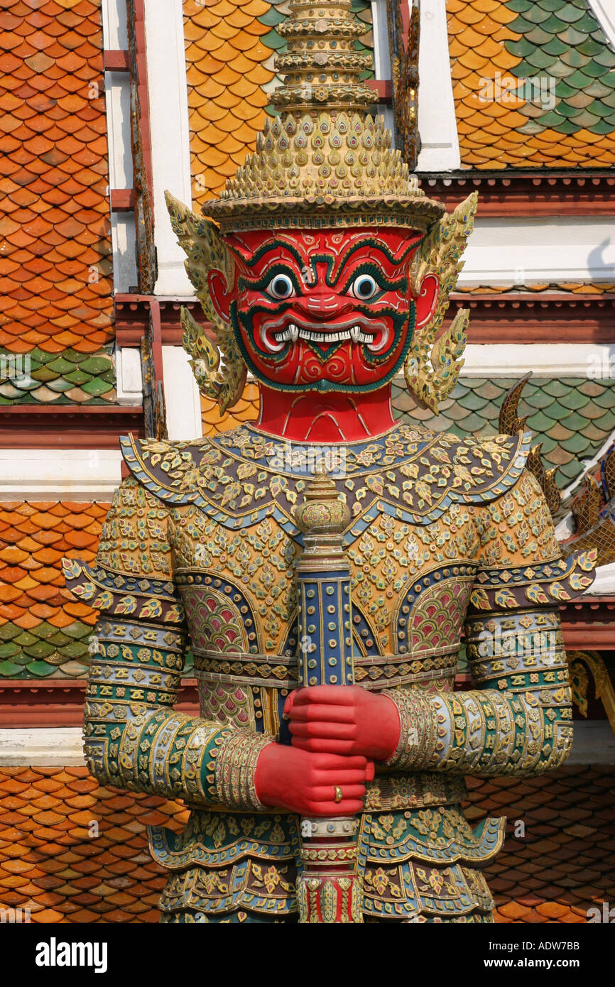 Large red guardian statue stands at an entrance to the Grand Palace ...