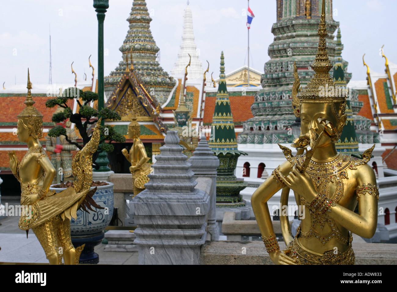 Golden guardian statues stand in the grounds of the Grand Palace ...