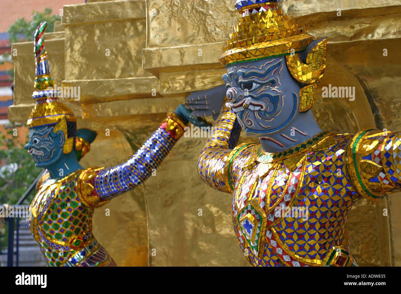 Colourful guardian statues stand in the grounds of the Grand Palace ...