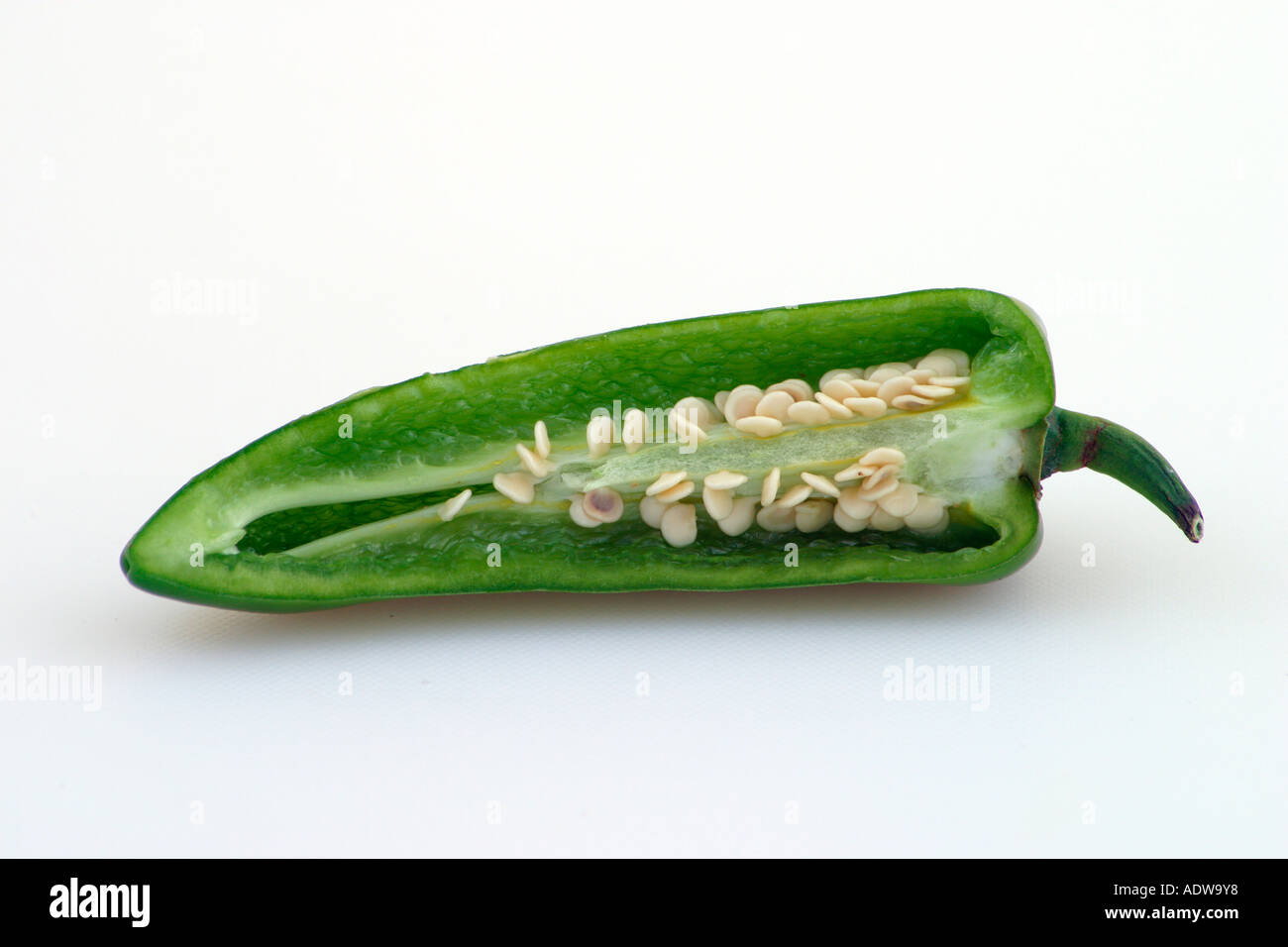 Green Chilli pepper sliced in half Stock Photo - Alamy