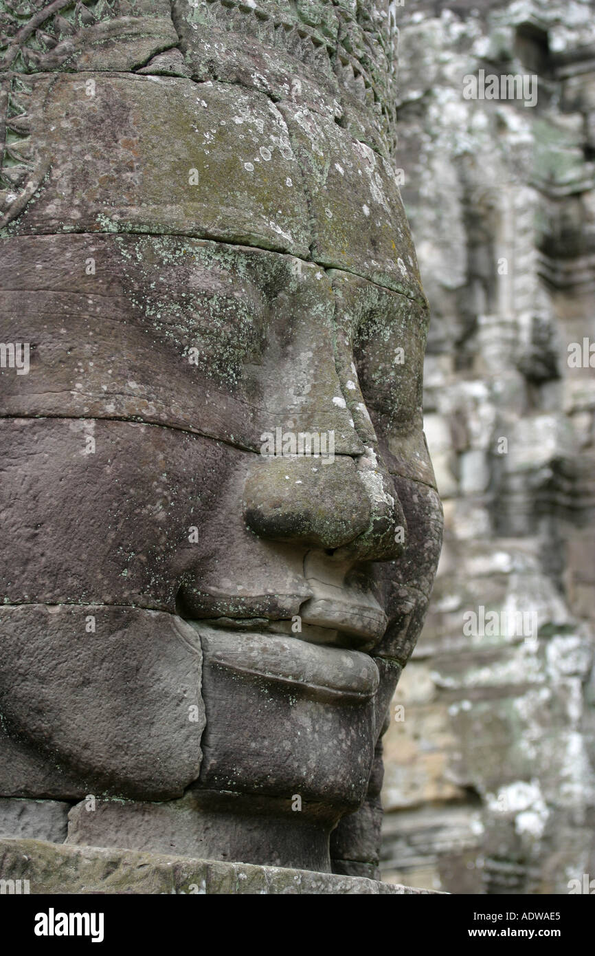 Closeup detail of a typical carved stone head on the famous Bayon ...