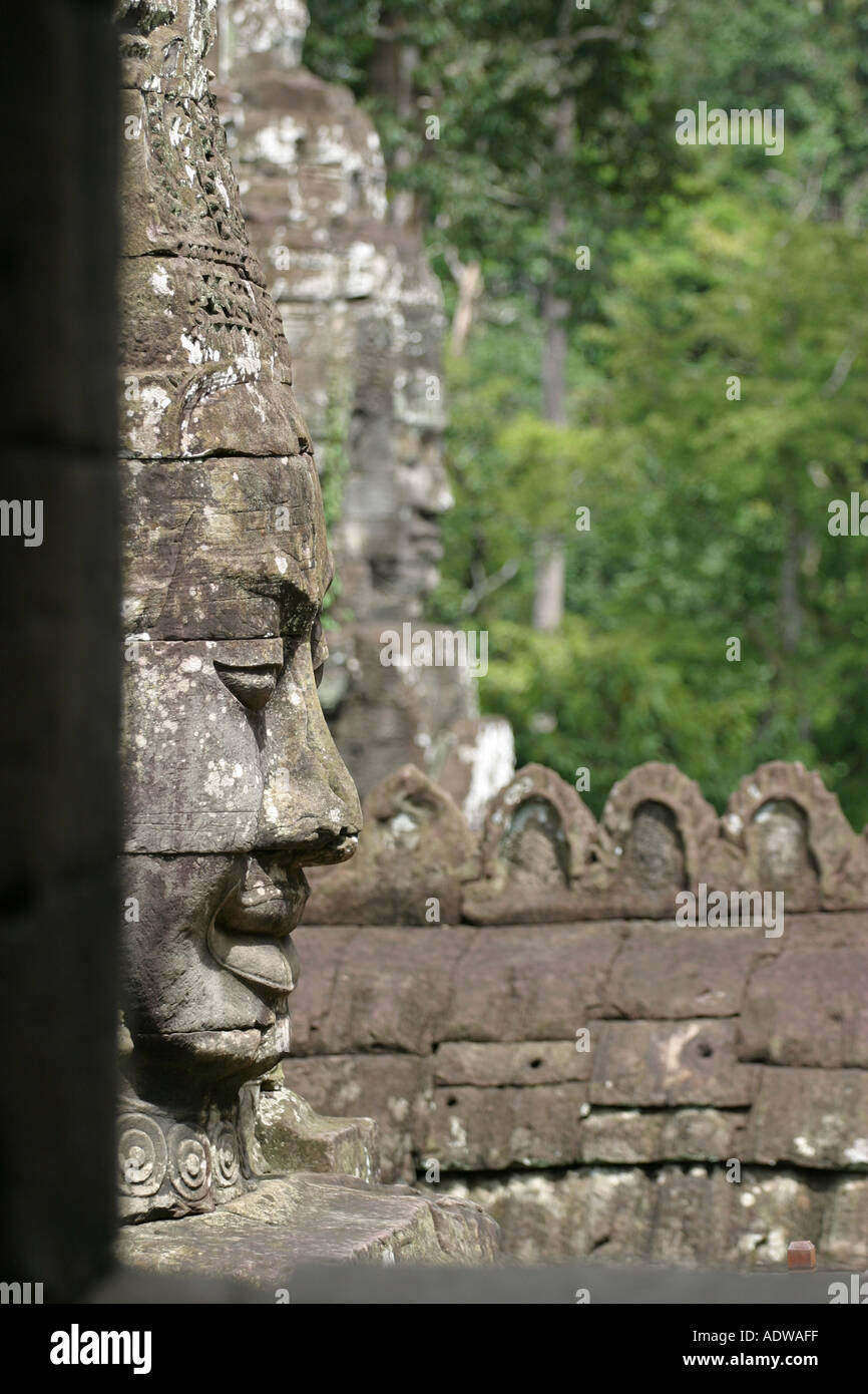Massive stone heads seen through an ancient stone window frame at the ...