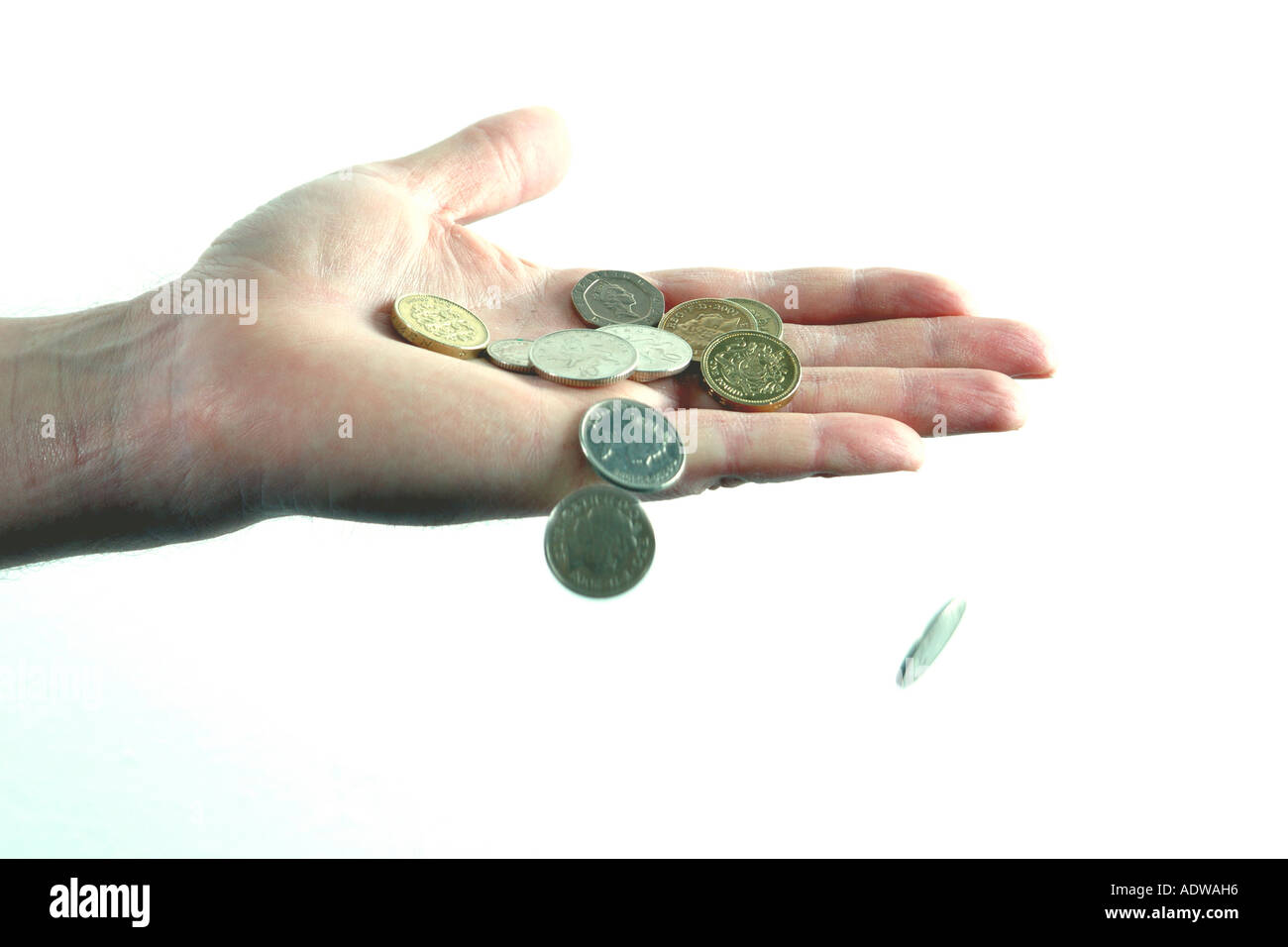 Coins falling through hand hi-res stock photography and images - Alamy