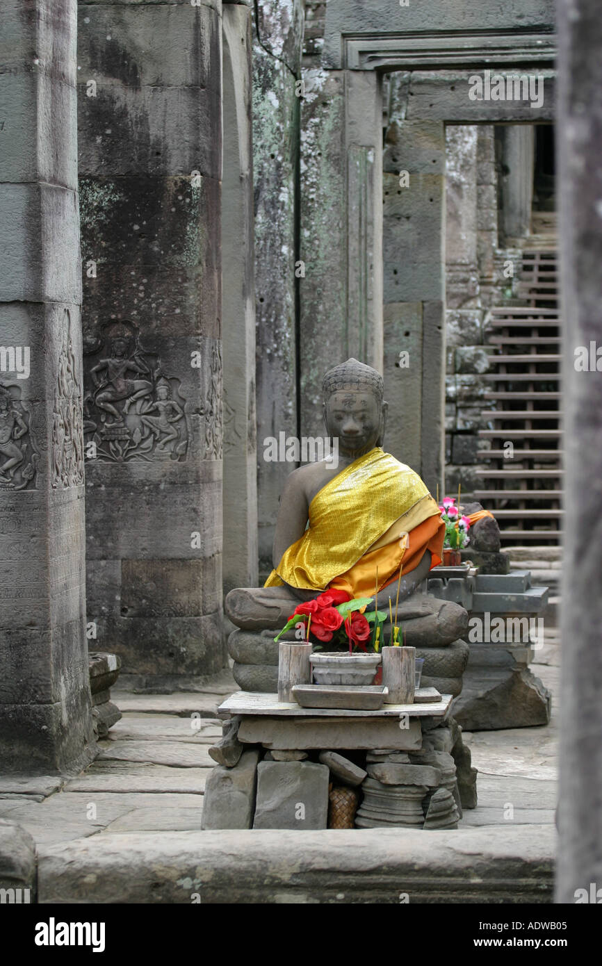 An ancient stone buddhist altar with burning incense in a mysterious ...