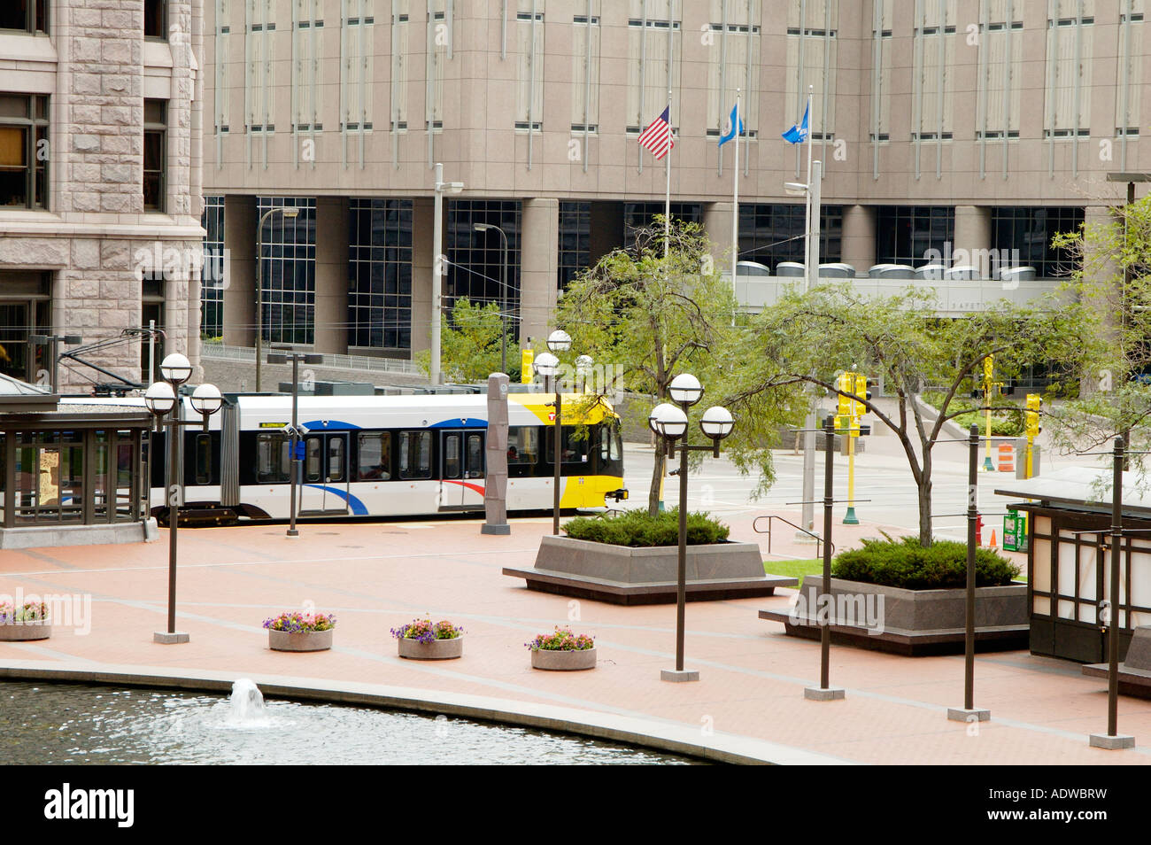 a light rail mass transit train in front of the government plaza ...