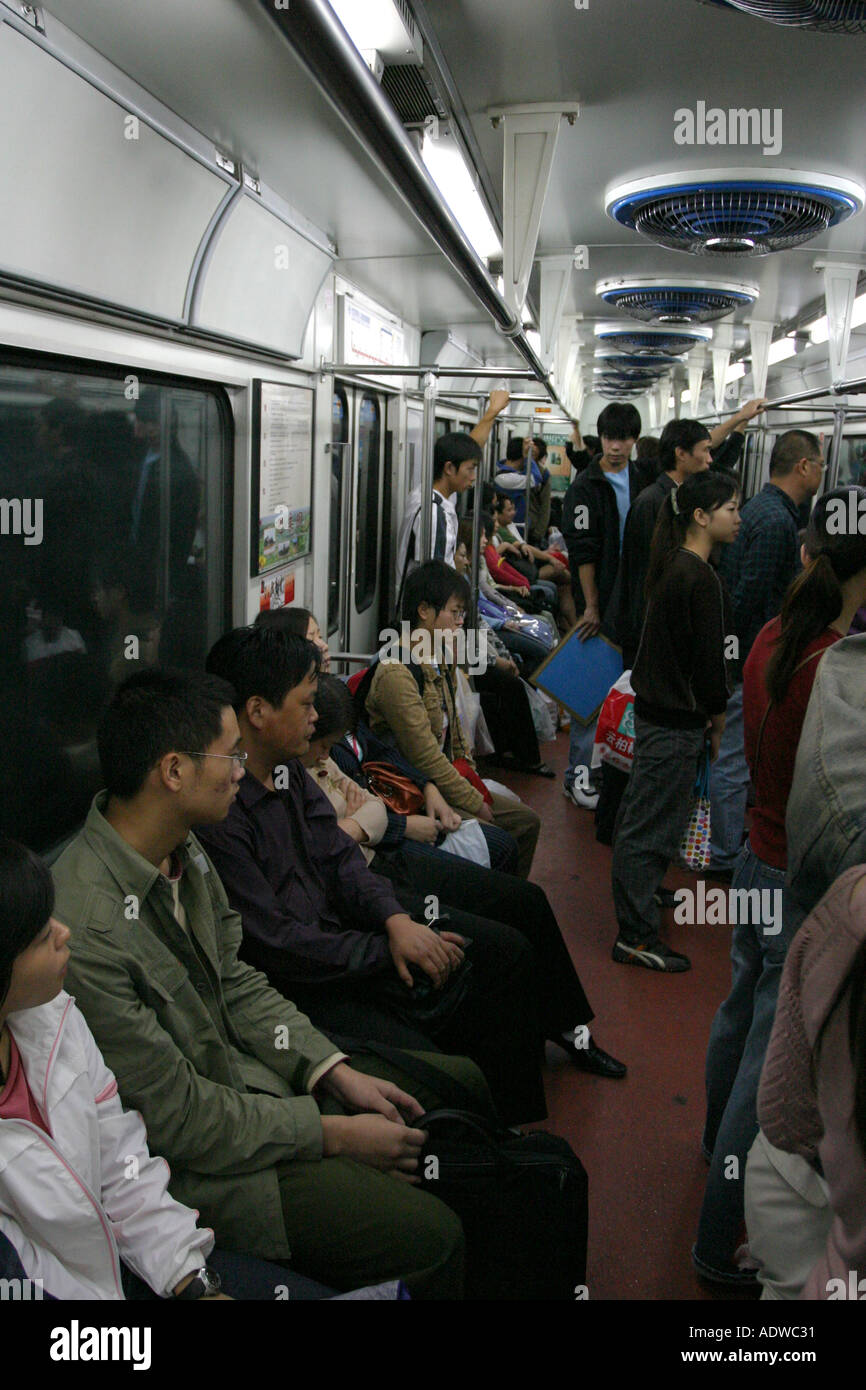 Commuters ride the Beijing subway during evening rush hour in Beijing ...