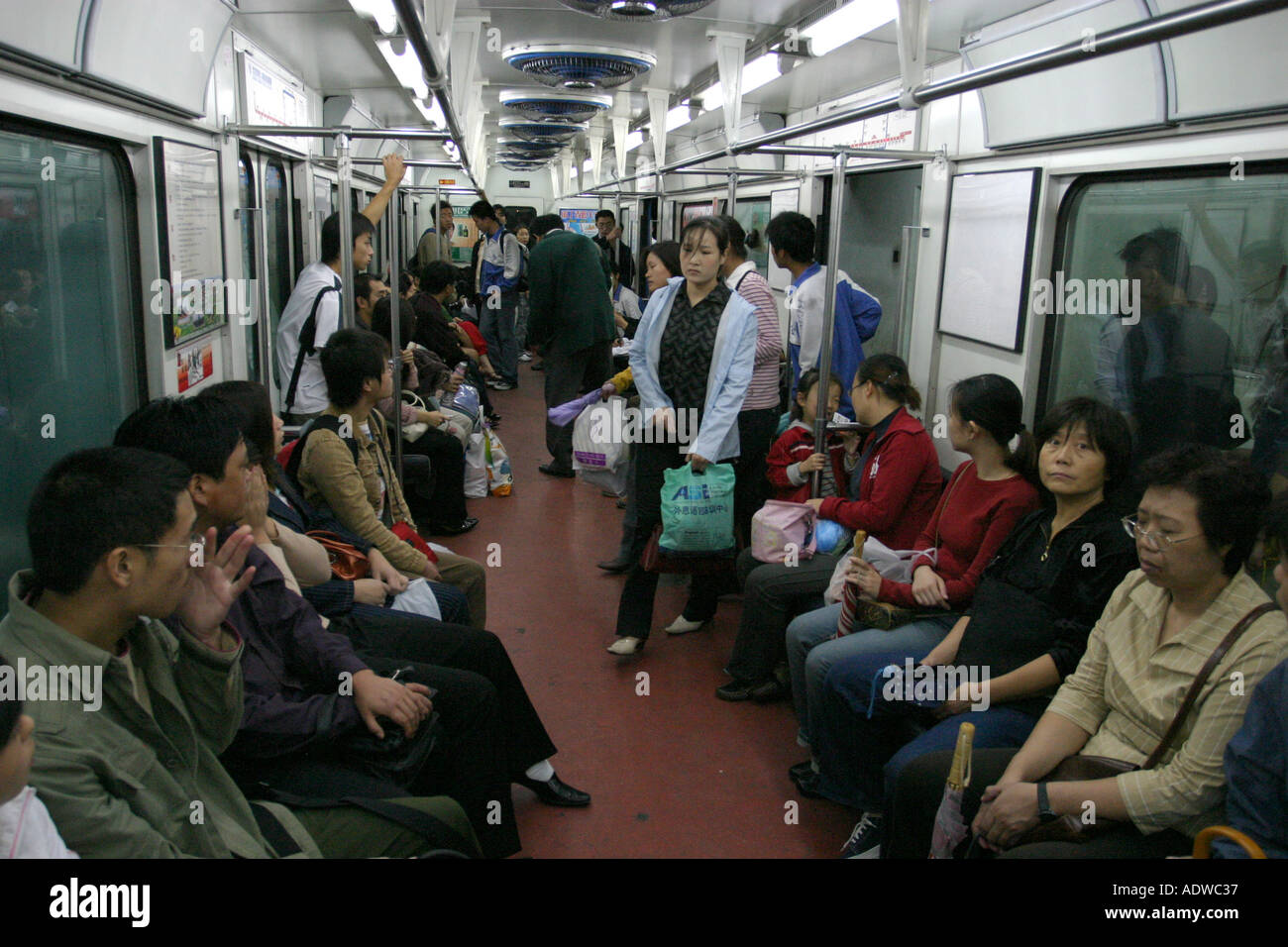 Commuters ride the Beijing subway during evening rush hour in Beijing ...