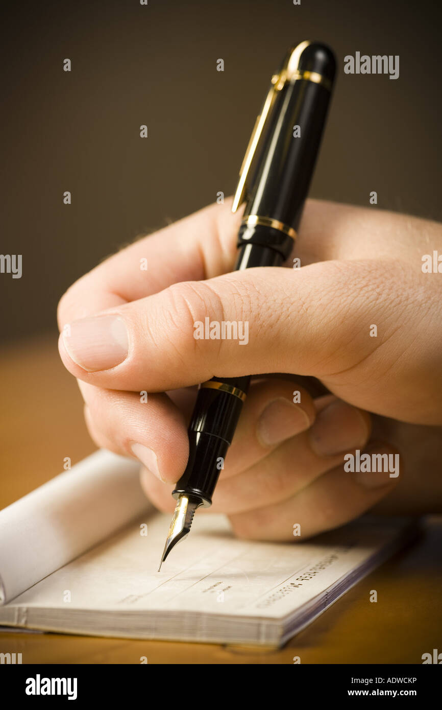 Detailed view of man holding fountain pen and endorsing check Stock ...