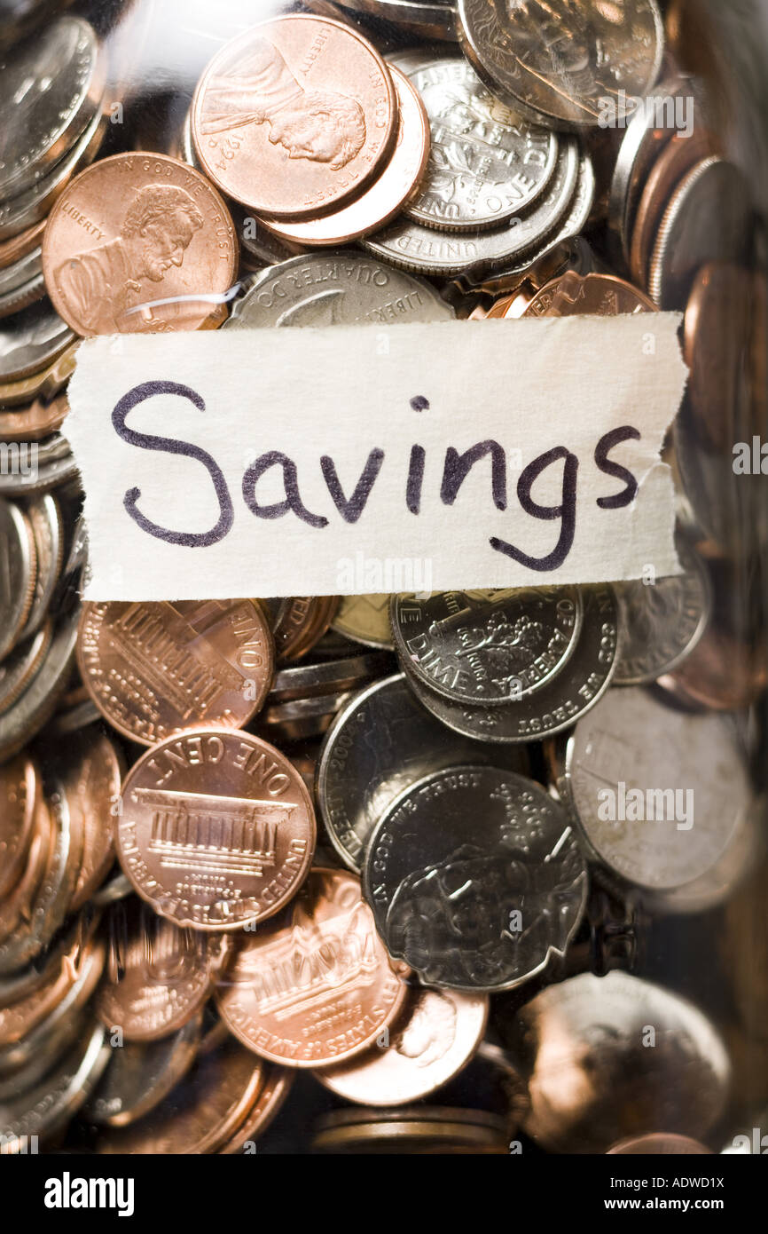 Detailed view of glass jar with coins and Savings label Stock Photo - Alamy
