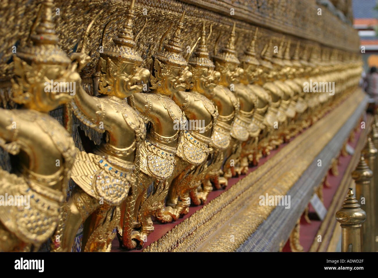 Golden statues stand guard outside a temple in the Grand Palace Bangkok ...