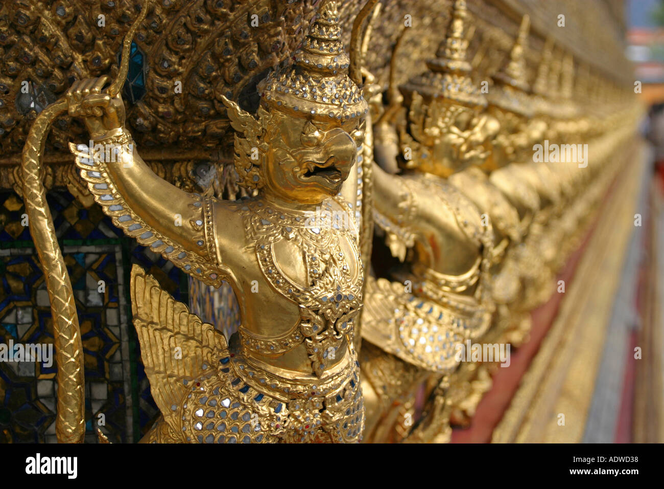 Close up detail of a golden guardian angel statue at the Grand Palace ...