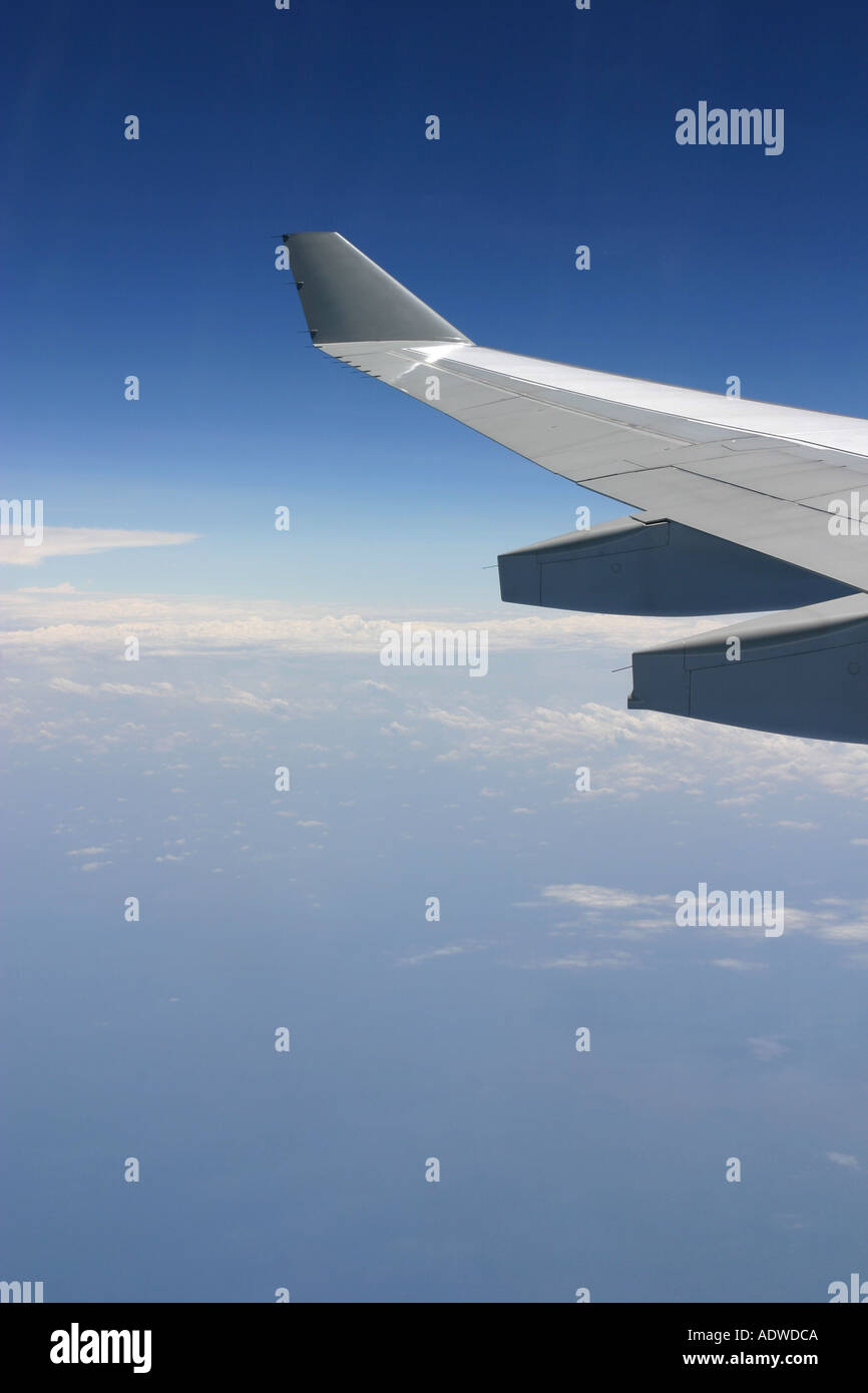 View of a commercial airliner wing through the window of a passenger ...