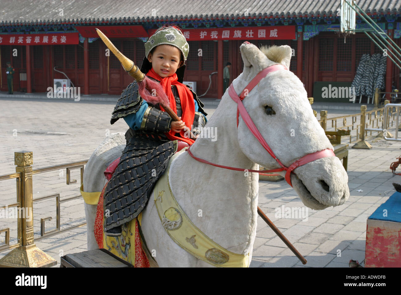 A young chinese child poses in traditional costume for family photos in ...
