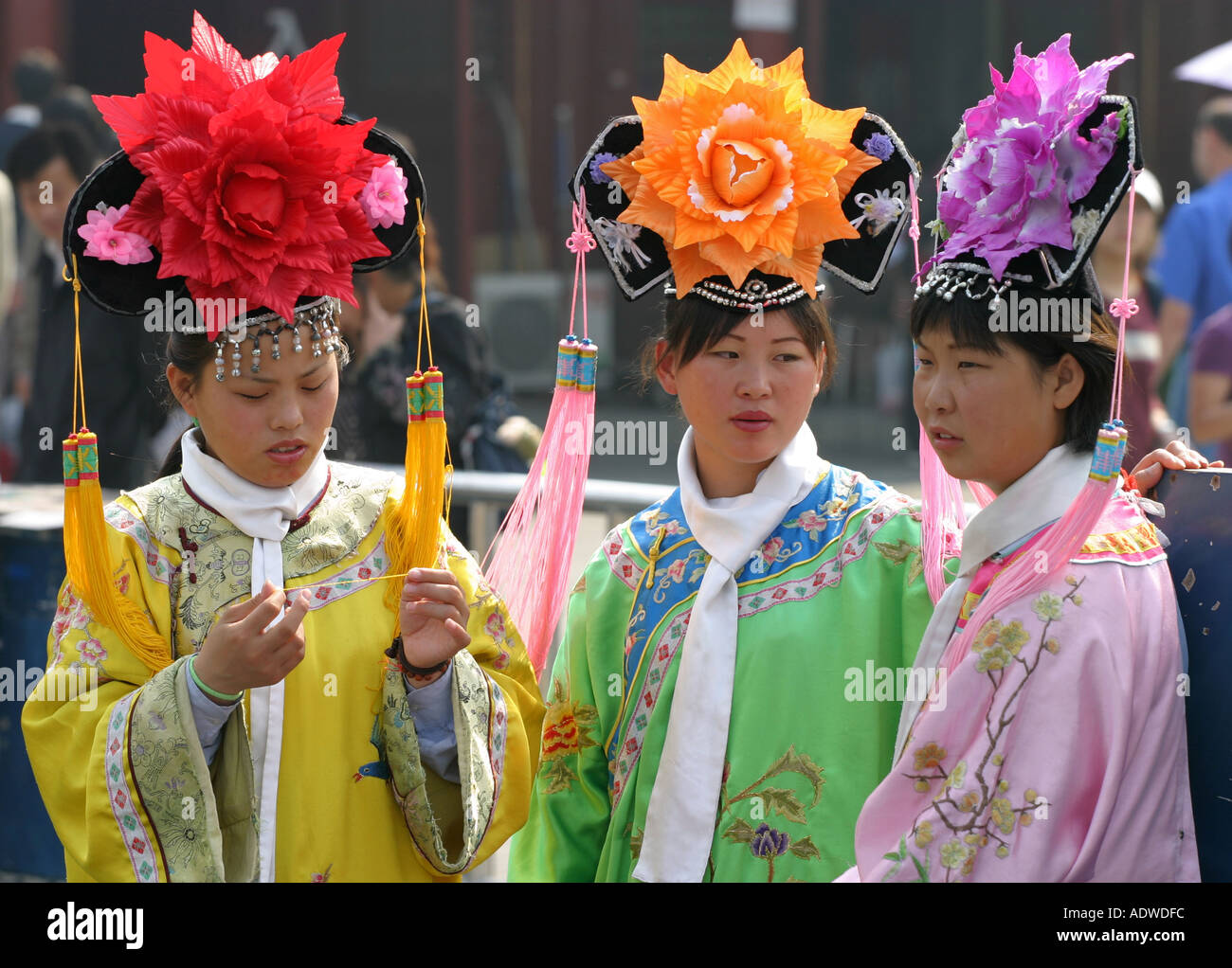 Young Chinese women wear traditional bright ceremonial costumes in the ...