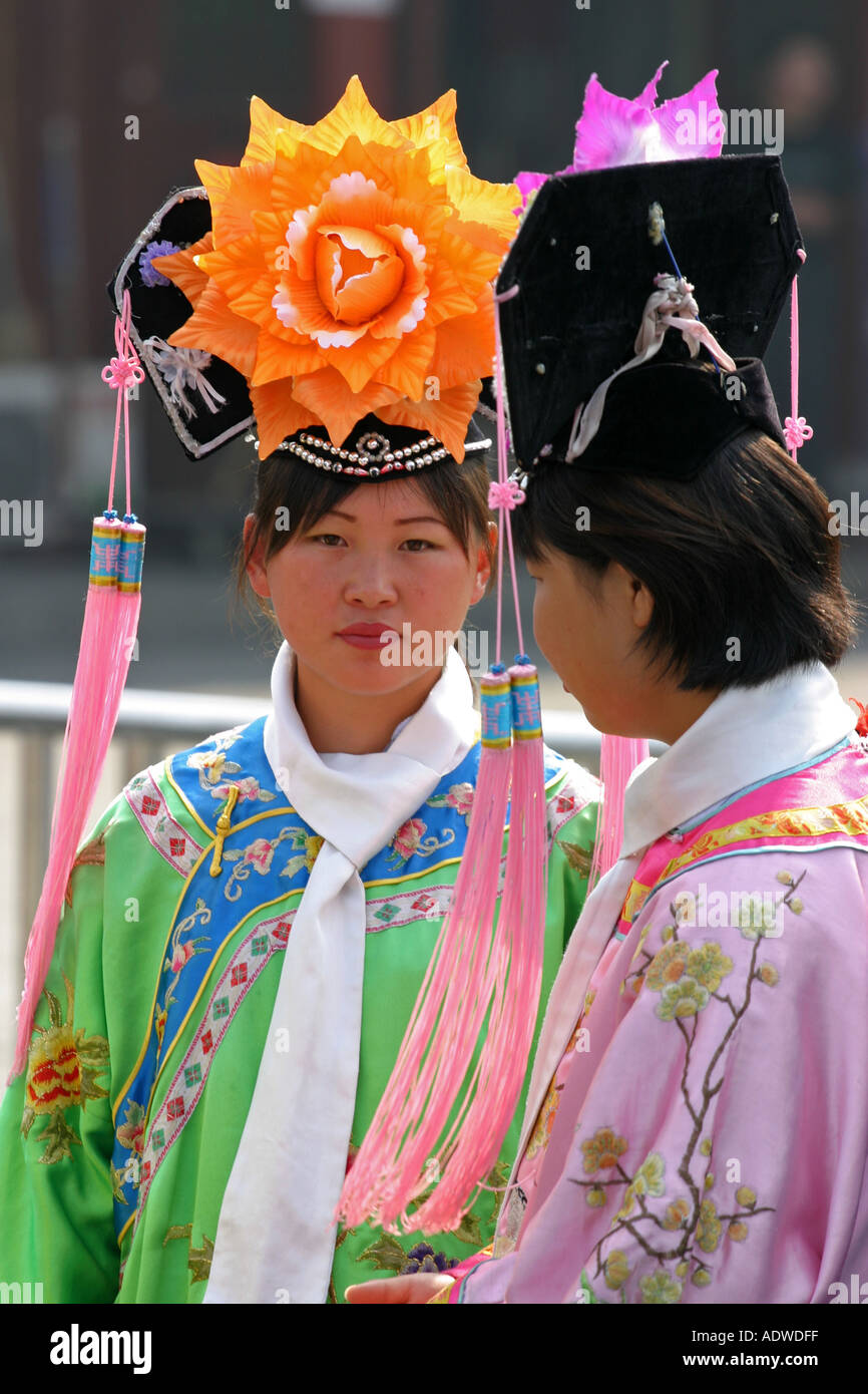 Young Chinese women wear traditional bright ceremonial costumes in the ...
