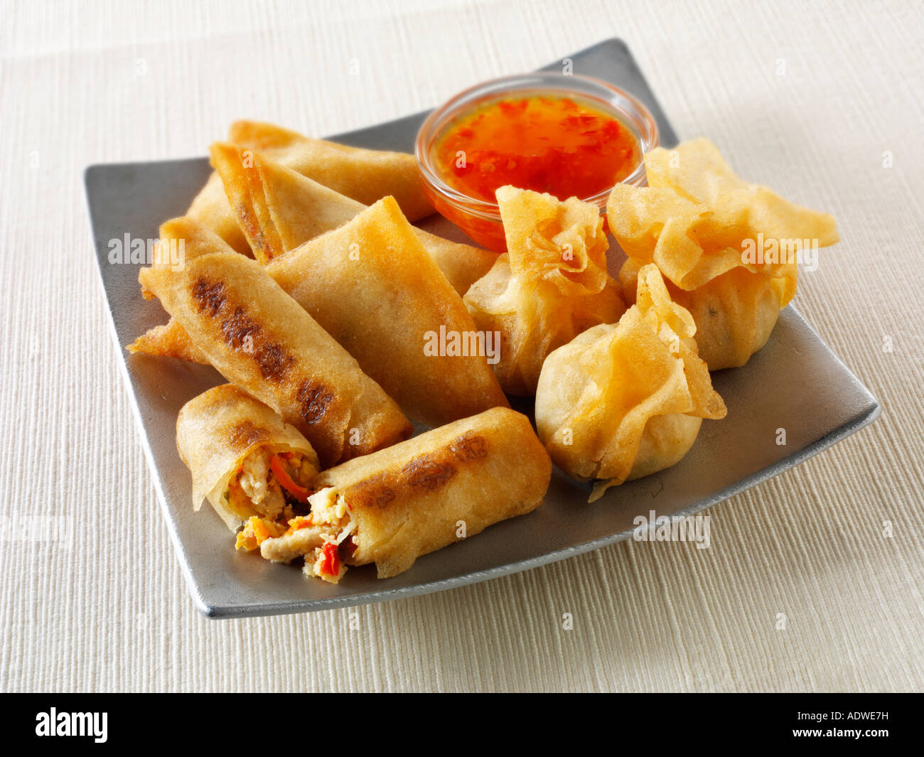 Oriental selection with dim sum spring rolls with chicken vegetables and vegetable samosas Stock ...