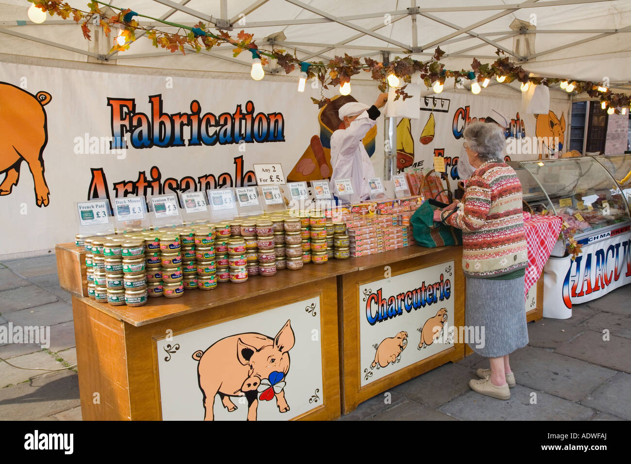 French Market food stall counter displaying products with lady shopping ...