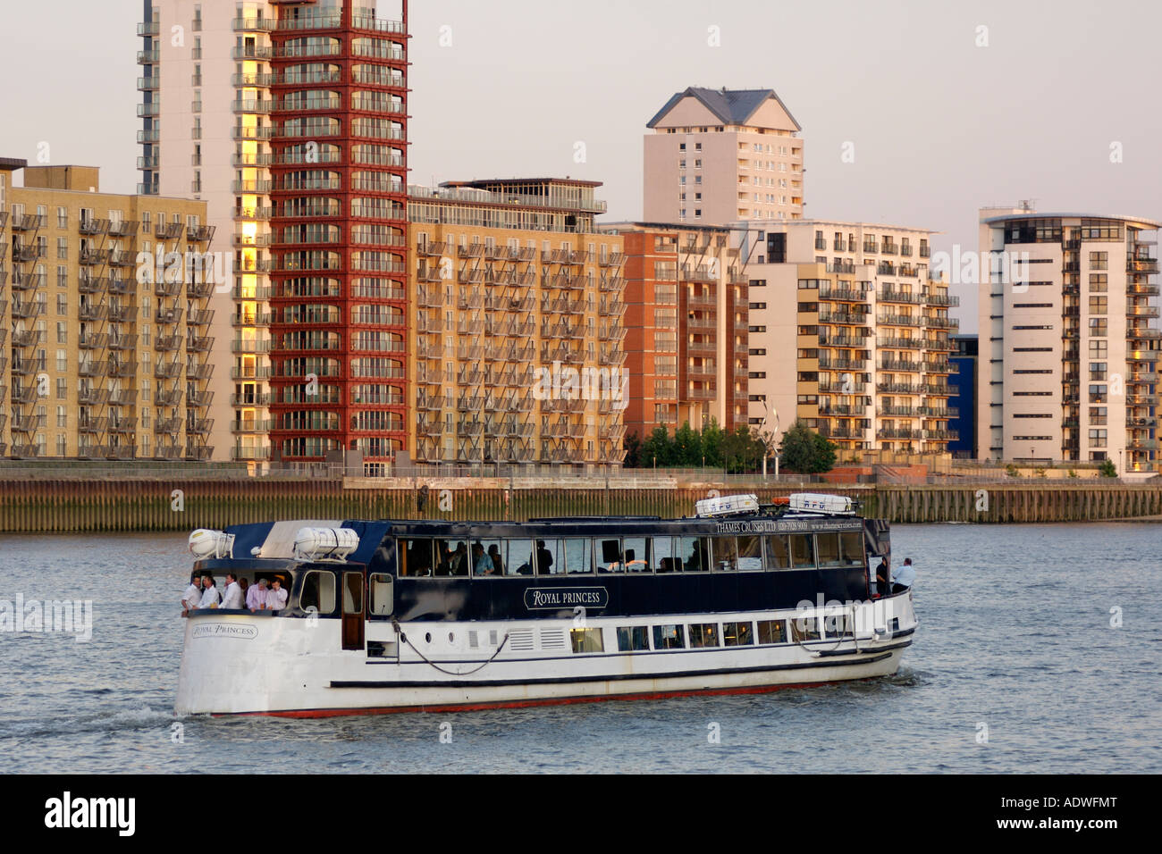 View of a Thames River pleasure boat cruising past the apartment ...