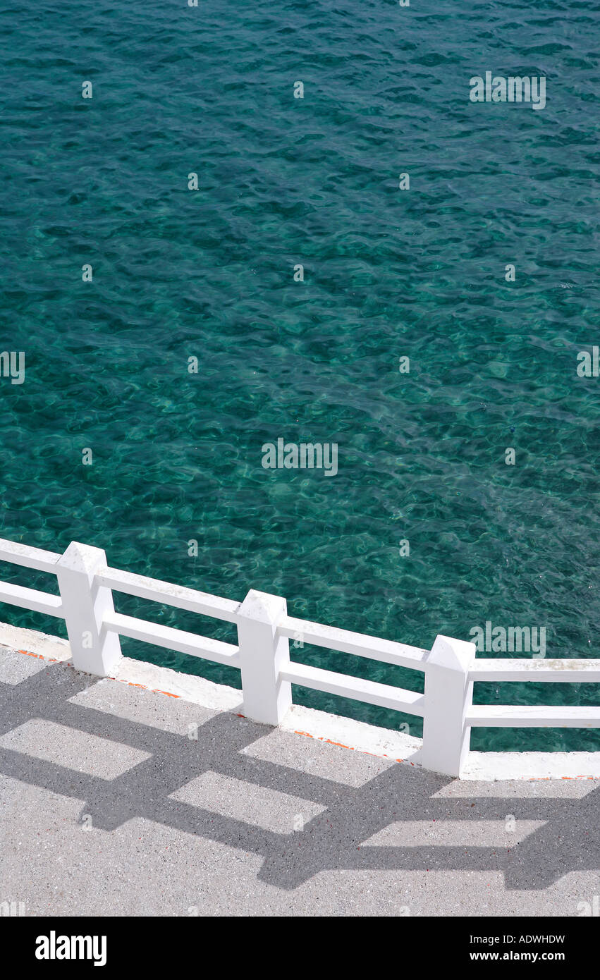 Promenade fence and Sunny Green Sea in Spain Stock Photo - Alamy