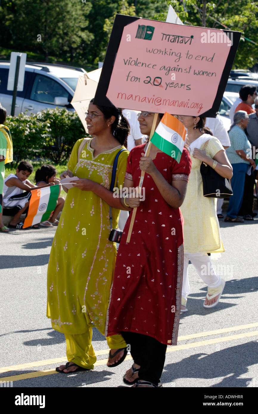 Two Indian Woman carry sign reading Manavi working to end violence ...
