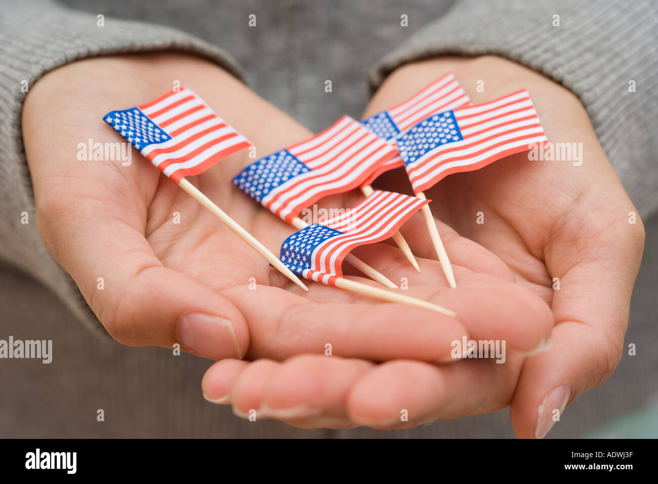 Hands holding small US flags Stock Photo - Alamy