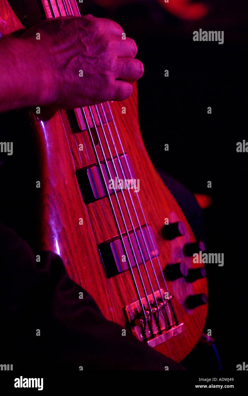 Electric bass played upright style Stock Photo - Alamy