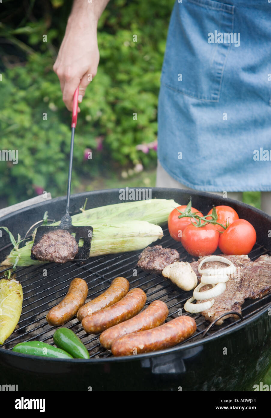 Grilling food outdoors in summer Stock Photo - Alamy